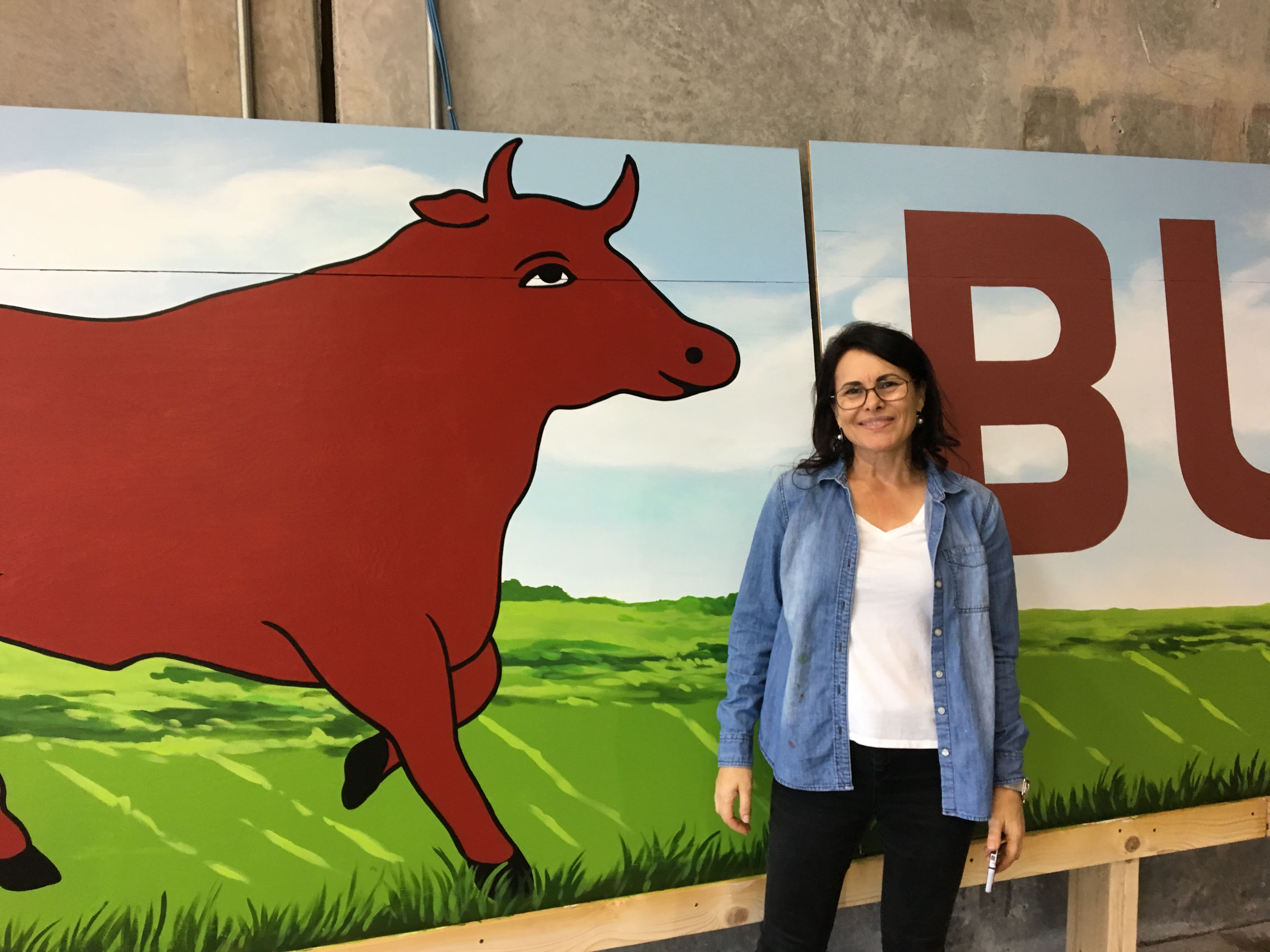 Mural artist Georgeta Fondos in front of her mural - Murals By Georgeta